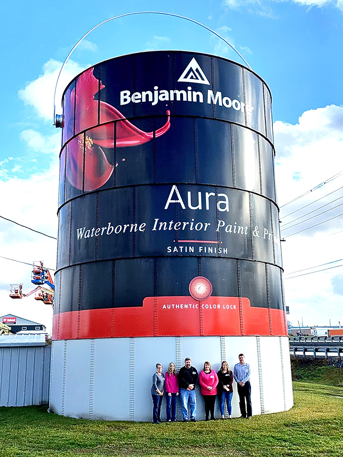 Size matters! This group of visitors demonstrates just how massive this paint container truly is. That's a lot of eggshell finish.