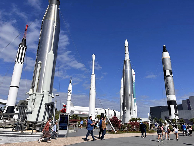Visitors stroll among giants of engineering, their upward glances mirroring the trajectory of the rockets that surround them.