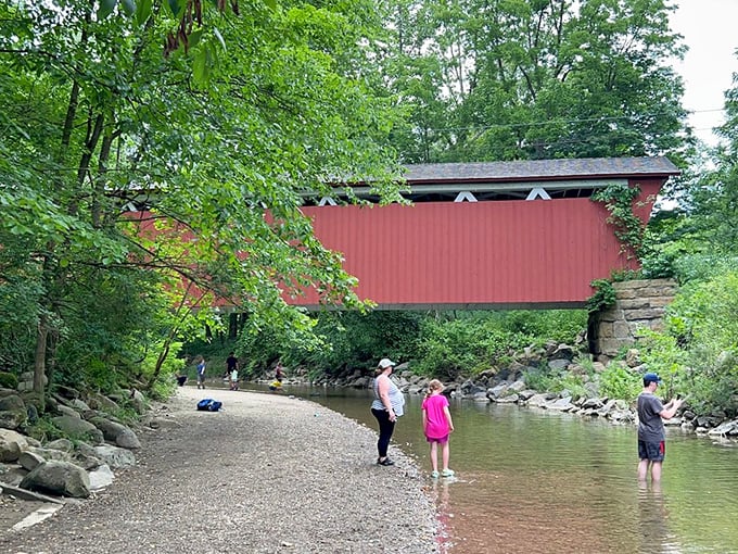 The view from below offers a different perspective, where families can dip their toes in the creek while admiring engineering from another era.