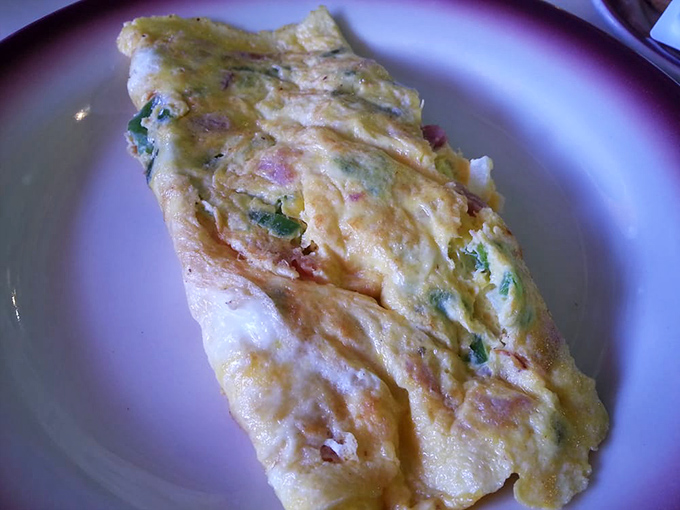 This Western omelet doesn't just contain ingredients&mdash;it embraces them in a fluffy egg blanket that's been perfected over decades of morning service.