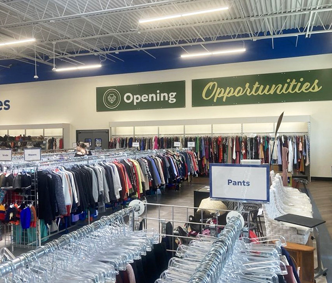 The clothing section stretches toward the horizon like a textile ocean. "Opening Opportunities" isn't just a sign&mdash;it's the store's entire philosophy.