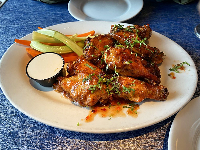 These wings aren't just crispy, they're life-affirming&mdash;glistening with sauce and garnished with fresh herbs that elevate them from bar food to culinary statement.
