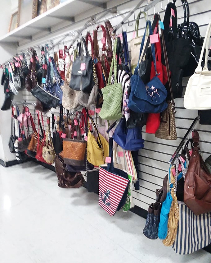 Handbag heaven! A colorful cascade of purses, totes, and clutches hanging like fashionable fruit ready for picking.