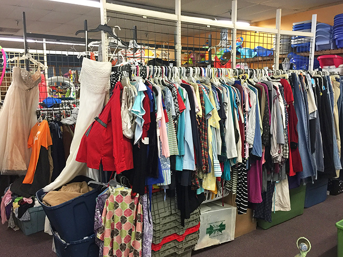 The clothing racks tell stories of growth spurts and special occasions, with formal wear hanging hopefully beside everyday essentials.