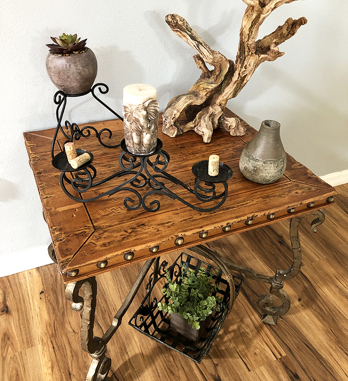 A rustic table vignette that whispers "I've watched too many home renovation shows" but in the most charming way possible. Driftwood meets wrought iron in perfect harmony.