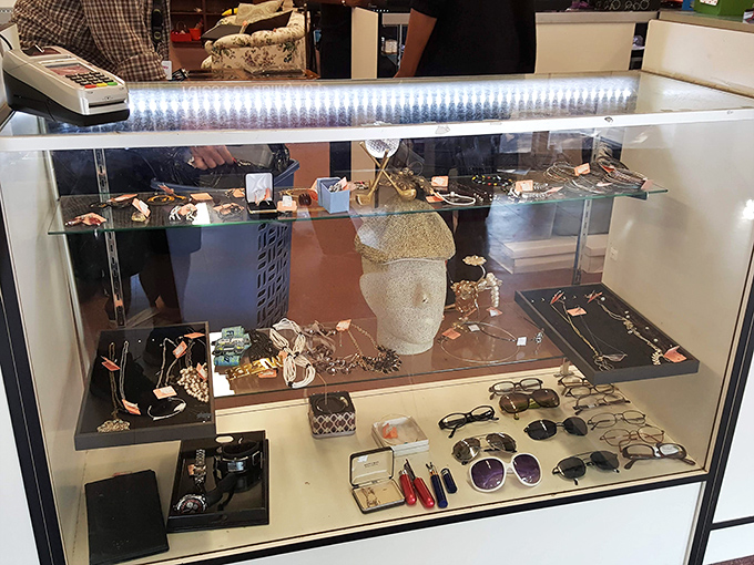 The jewelry counter: where yesterday's accessories await tomorrow's outfits, all protected under glass like museum pieces at garage sale prices.
