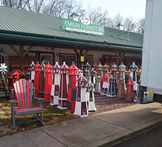 Lighthouse lawn ornaments stand at attention outside the Amish Furniture store – because even your garden deserves craftsmanship.