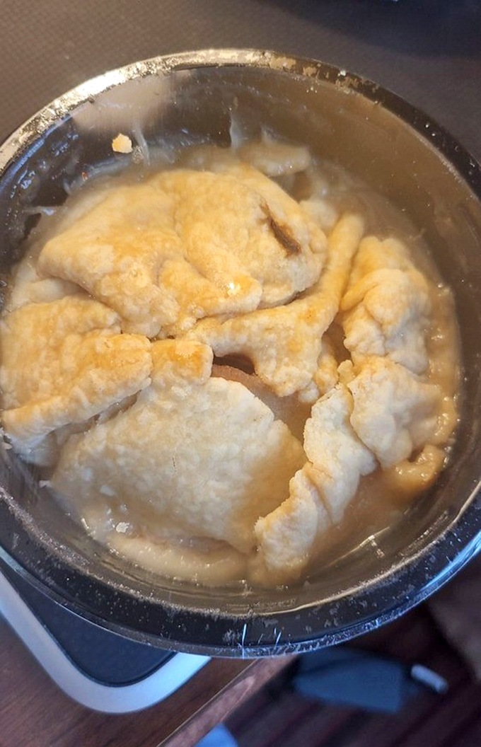 Apple dumplings swimming in golden sauce, proving that some comfort foods transcend all dietary resolutions.