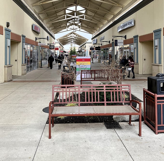 Strategic rest stations with benches offer shoppers a moment to contemplate their next retail conquest or simply rest weary feet between bargain battles.