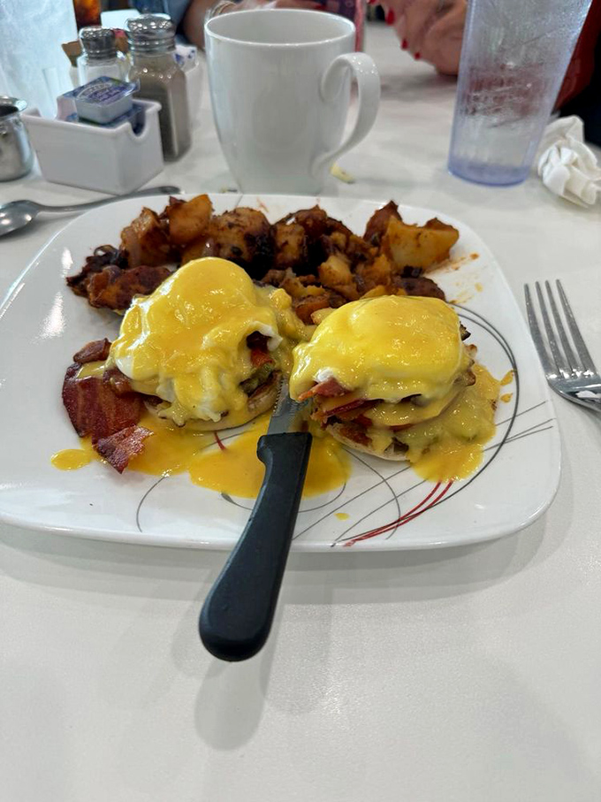 Eggs Benedict: where hollandaise becomes liquid gold and breakfast ascends to art form. Those home fries deserve their own fan club.
