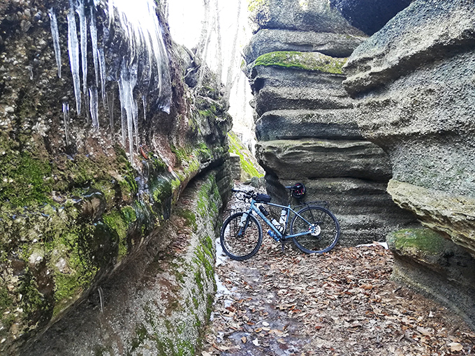 Even the most dedicated cyclists occasionally admit defeat. This bike taking a breather between towering rock walls reminds us that some journeys are best continued on foot.