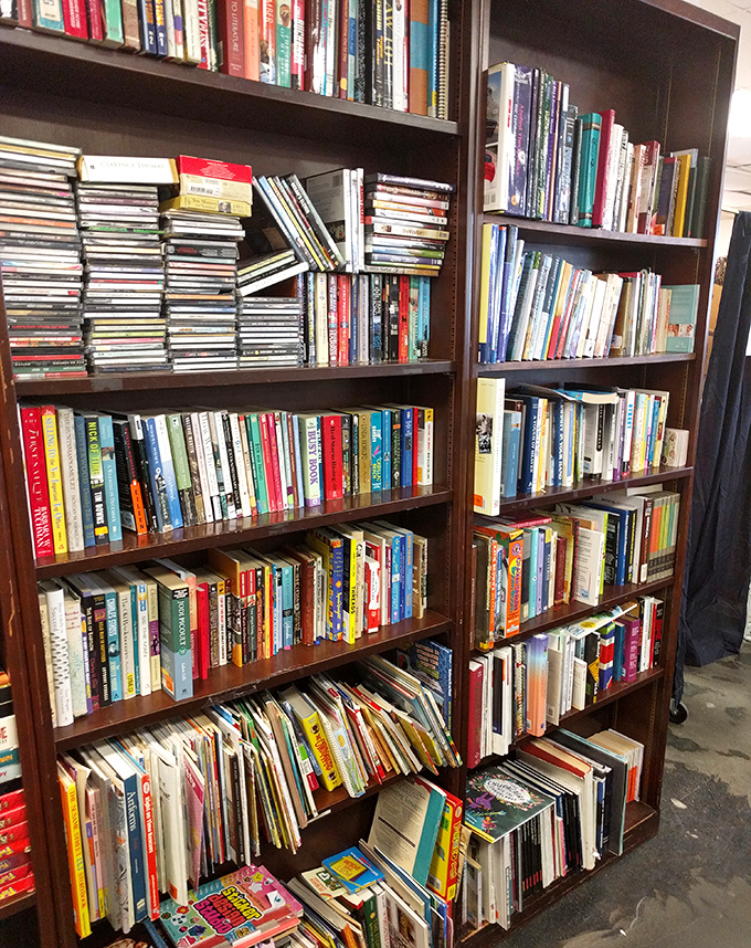Literary treasures stack floor to ceiling, a bibliophile's dream where dog-eared paperbacks and pristine hardcovers coexist in perfect harmony.