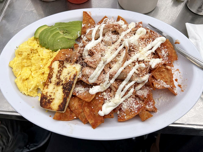 Chilaquiles that would make your abuela nod in approval. The marriage of crispy tortilla chips, eggs, and that drizzle of crema creates a breakfast fiesta worth celebrating.