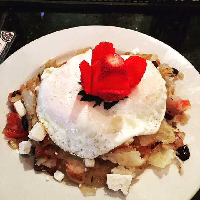 Breakfast architecture at its finest&mdash;a sunny-side-up egg crowning a foundation of savory potatoes. That strawberry "flower" is showing off.