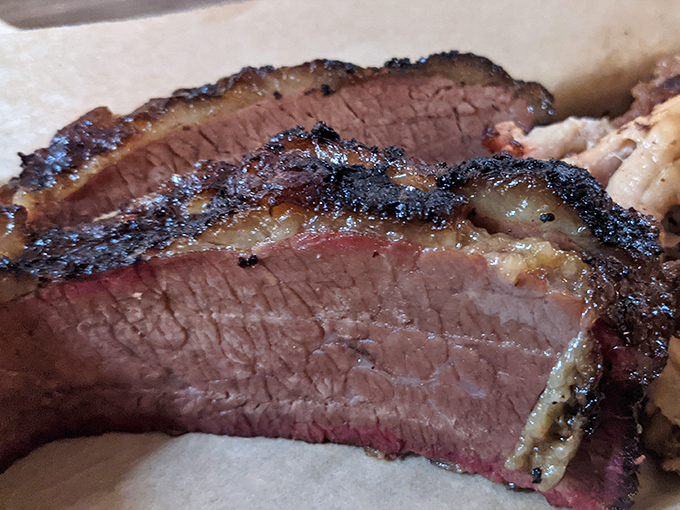 Look at that bark! This brisket cross-section reveals the holy trinity of barbecue perfection: smoke ring, rendered fat, and a crust that deserves its own fan club.