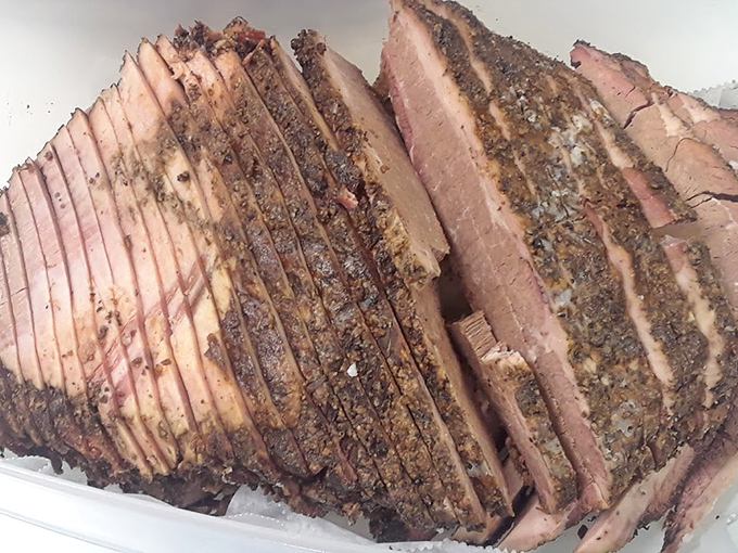 Brisket sliced with the precision of a surgeon, complete with that coveted smoke ring. Each slice tells the story of hours in the smoker.