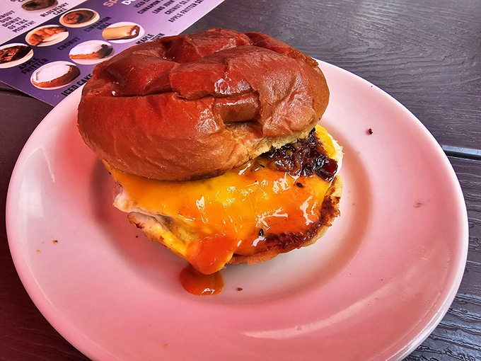 Not just a sandwich but an engineering marvel&mdash;melted cheese cascading down a burger nestled in a glossy bun that deserves its own architectural award.