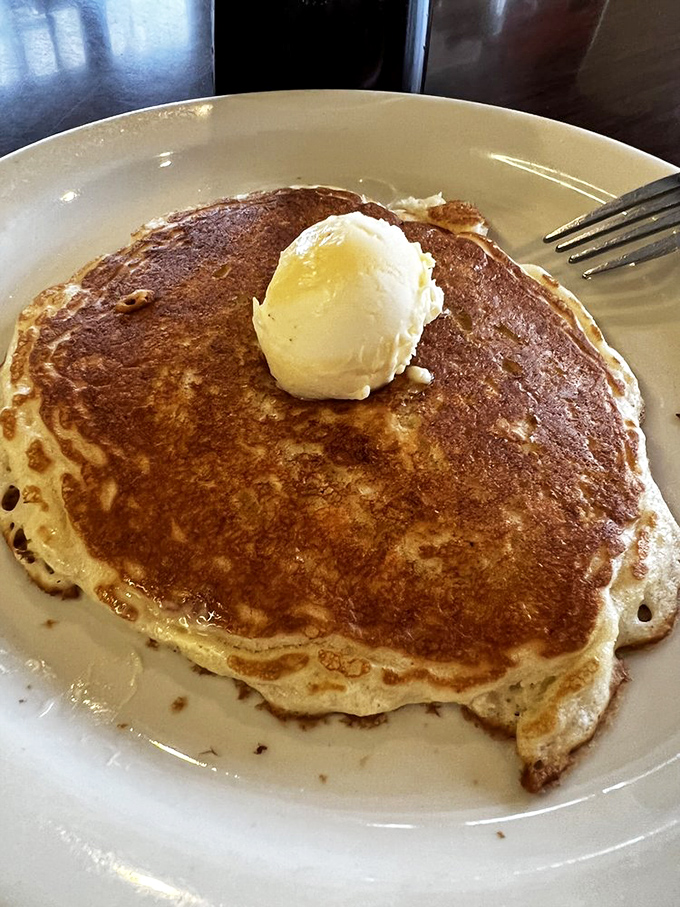 That perfect pancake moment: golden surface, pat of butter slowly melting. Whoever said "you can't buy happiness" never had this for breakfast.