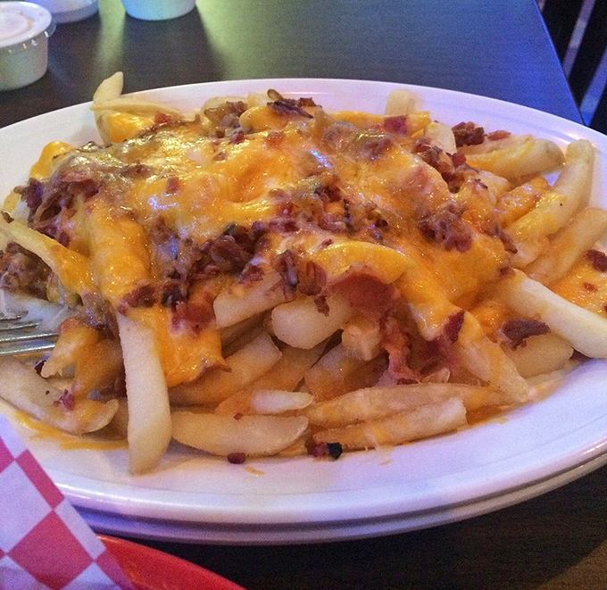 These aren't just cheese fries; they're a commitment to excess done right&mdash;crispy potatoes smothered in melted cheese and bacon bits that demand to be shared.