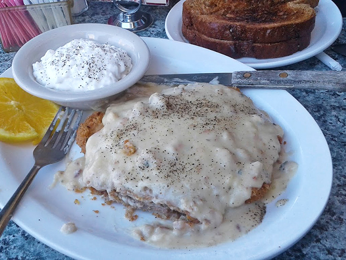 Chicken fried steak swimming in country gravy&mdash;the kind of breakfast that makes you want to cancel your plans and take a delicious nap instead.