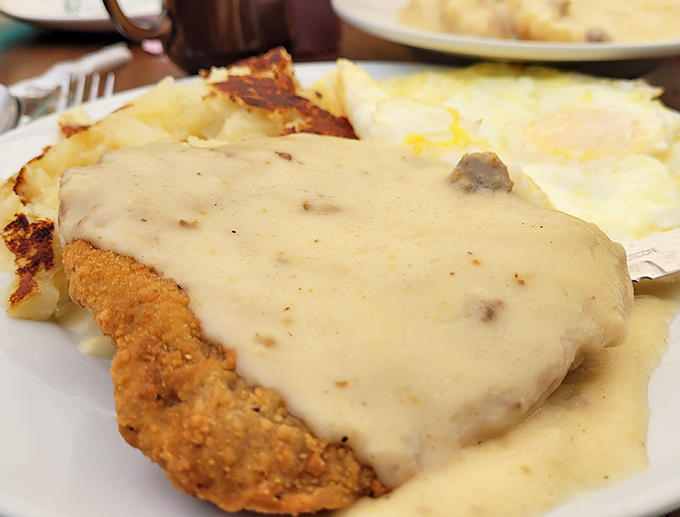 That golden chicken fried steak drowning in gravy is basically a warm hug on a plate.