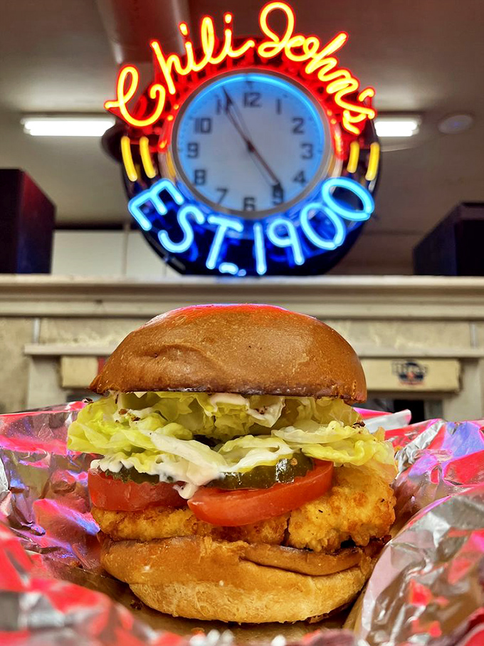 Even the chicken sandwich knows its role at Chili John's&mdash;honest comfort food served under the glow of that iconic neon clock.