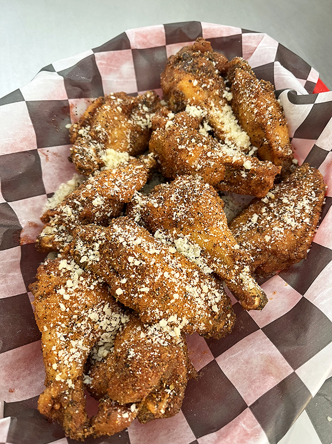 These aren't just wings—they're crispy vessels for parmesan perfection. The checkered paper is practically a racing flag signaling your taste buds to start their engines.