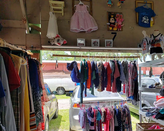 Children's clothing hangs hopefully, waiting for new owners in this charming stall where today's bargains become tomorrow's hand-me-downs.