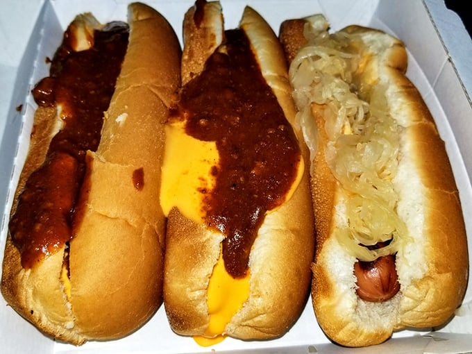 A symphony of chili dogs lined up like the Rockettes, each one dressed to the nines in sauce and cheese.