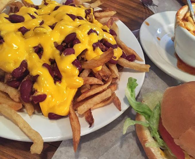 Chili cheese fries that laugh in the face of diet plans. The melty cheese cascading over crispy fries and hearty beans is worth every napkin.