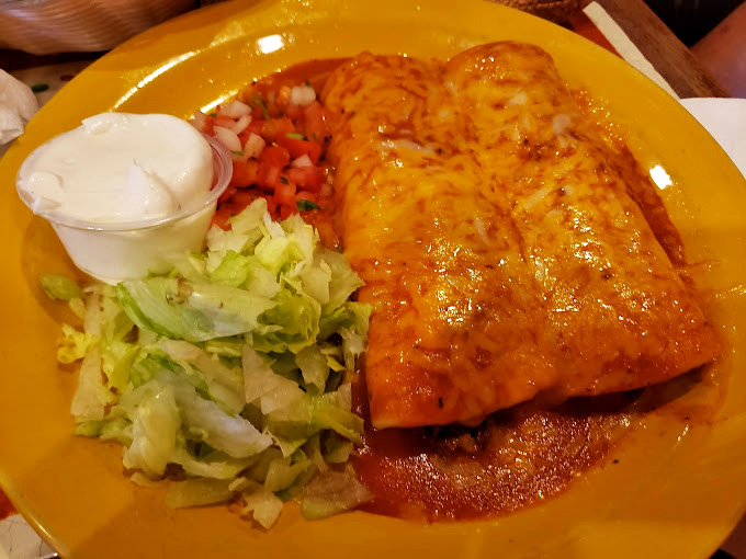 Behold the chimichanga in its natural habitat&mdash;crispy on the outside, tender within, and swimming in a vibrant sauce that demands to be sopped up.