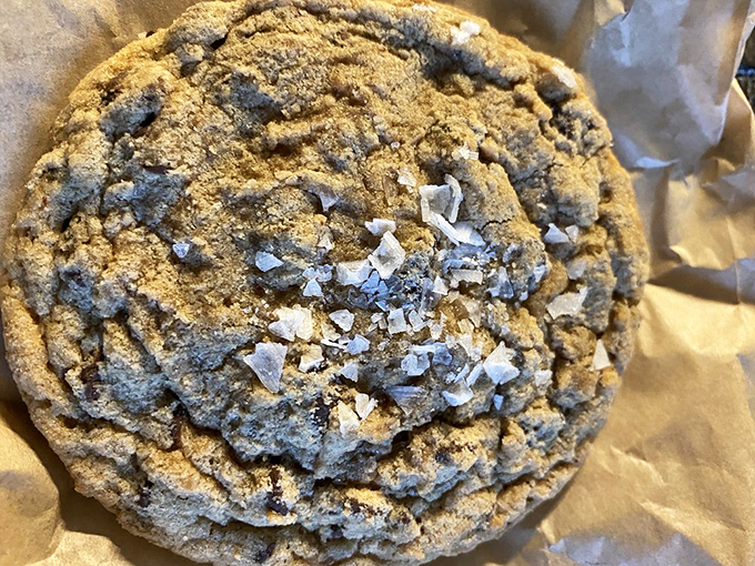 This chocolate chip cookie isn't just a treat—it's a textural masterpiece with sea salt flakes that dance across the surface like delicious snowflakes.