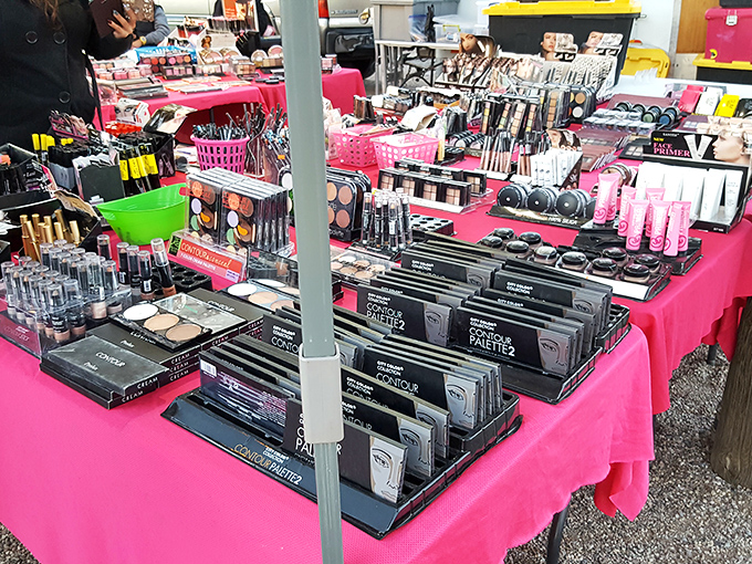 A makeup lover's dream spread across vibrant pink tablecloths. More cosmetics in one spot than in a Hollywood makeup trailer!