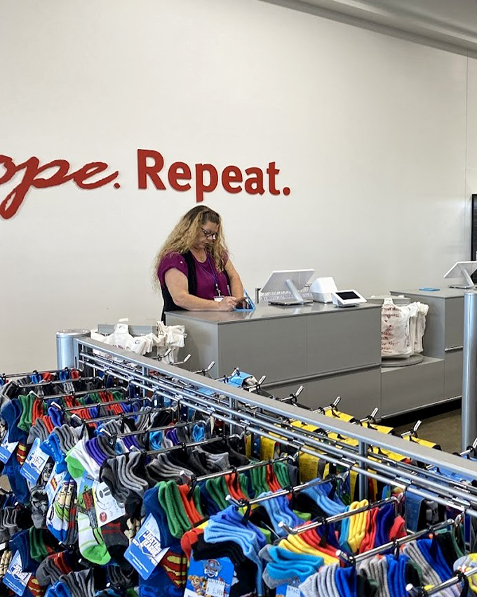 
Behind the counter, staff members help shoppers navigate their treasure hunt beneath the store's hopeful mantra&mdash;a retail philosophy in three simple words.