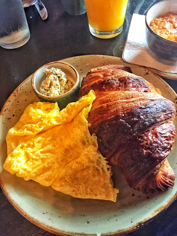 The croissant and eggs plate - where French technique meets Midwestern hospitality. That golden pastry shatters like delicious glass with each bite.