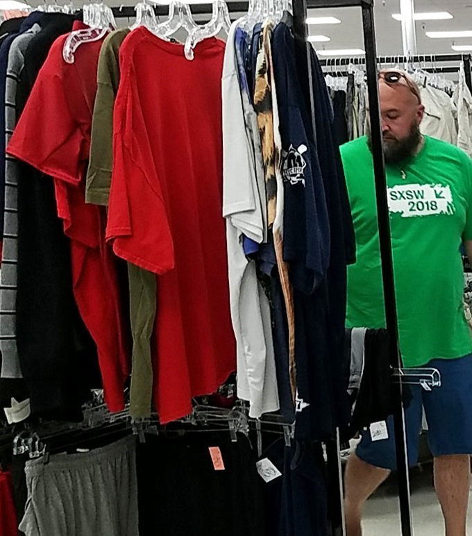 Serious thrifters develop a sixth sense&mdash;this shopper's focused expression says he's hunting something specific among the rainbow of options.