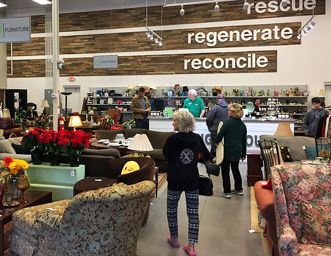 The store's mission of "rescue, regenerate, reconcile" hangs above shoppers browsing furniture pieces that deserve second chances in new homes.
