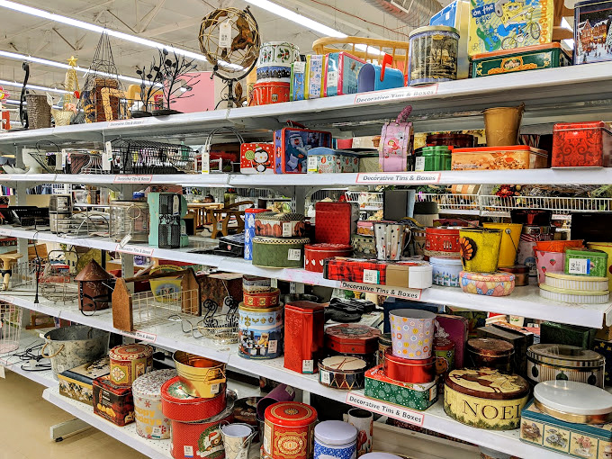 Vintage tins create a colorful mosaic of forgotten brands and nostalgic packaging from decades past.