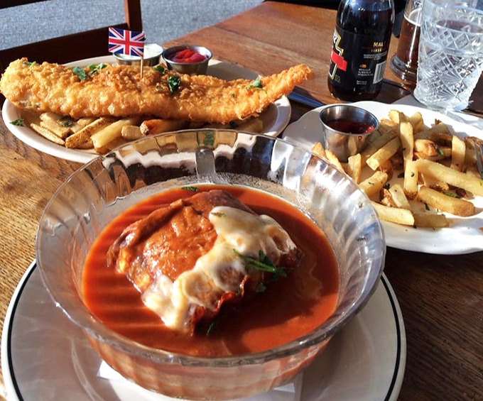 A feast fit for the Queen herself &ndash; crispy fish and chips alongside what appears to be eggplant parmesan in tomato sauce, showcasing Payne's impressive range.