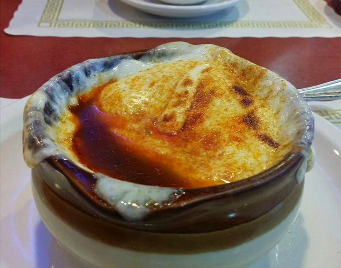 Behold the French onion soup in all its glory! That broiled cheese cap is nature's perfect lid, sealing in a broth that's been simmering since yesterday.