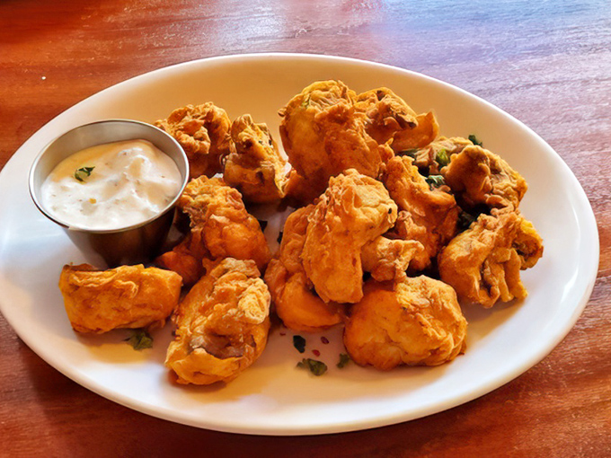Golden-battered mushroom clouds that explode with earthy flavor, paired with a creamy dipping sauce that makes vegetarians feel like they've won the lottery.