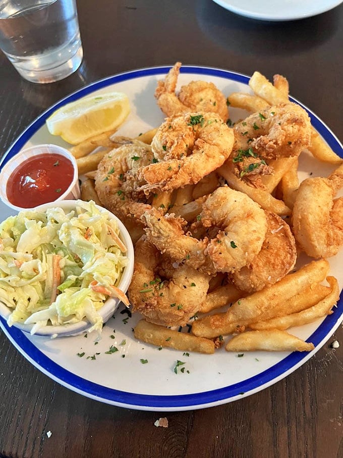The fried shrimp platter isn't just a meal, it's a celebration&mdash;golden treasures from the deep paired with crisp fries and tangy slaw.