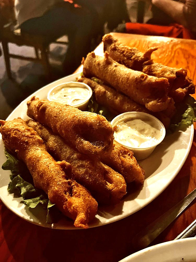 Golden-brown zucchini sticks that shatter with each bite, paired with dipping sauces that make vegetables feel like an indulgence rather than a obligation.