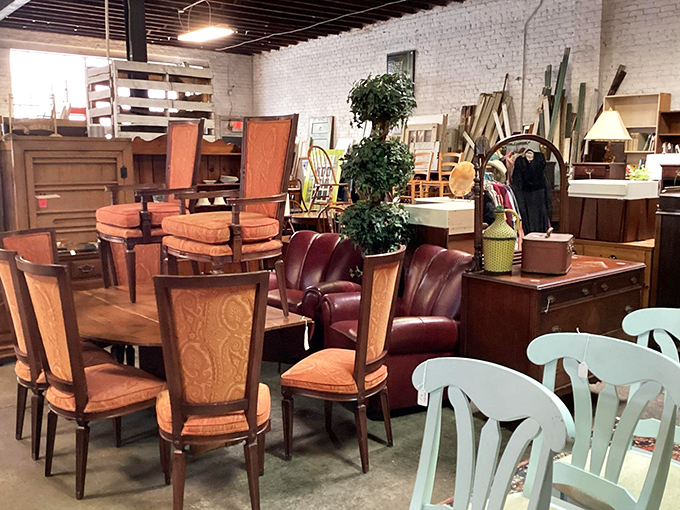 Mid-century dining chairs huddle around their table like old friends catching up. That leather armchair is practically begging for a bourbon and book.