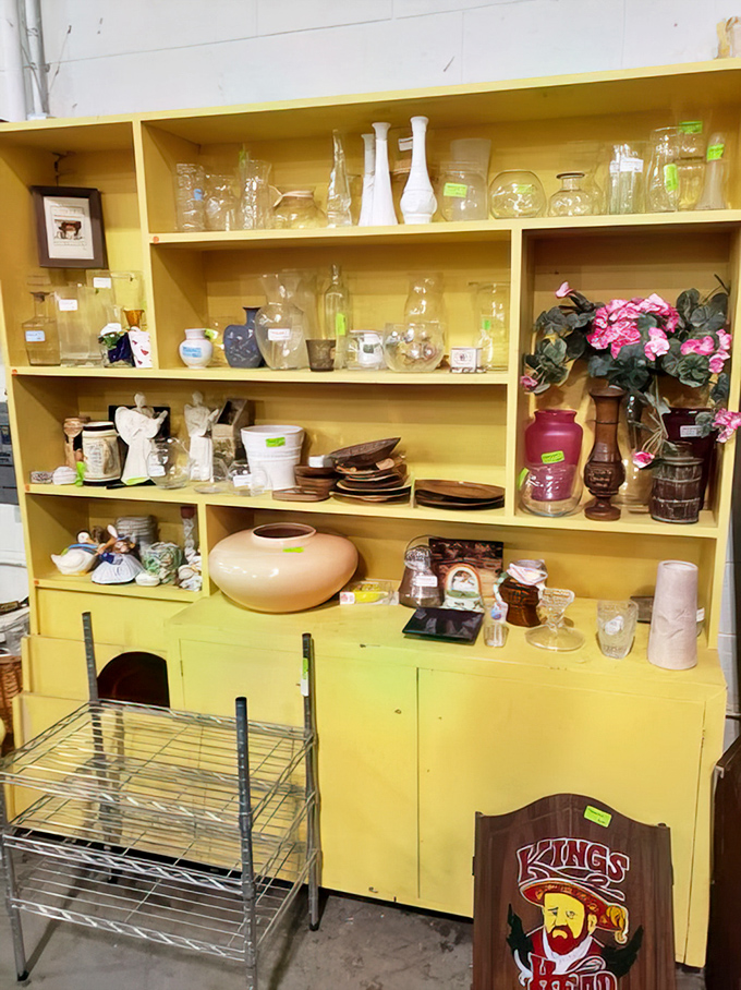 Yellow shelves bursting with glassware treasures. One person's "we got too many wedding gifts" is another's complete entertainment set for under $20.