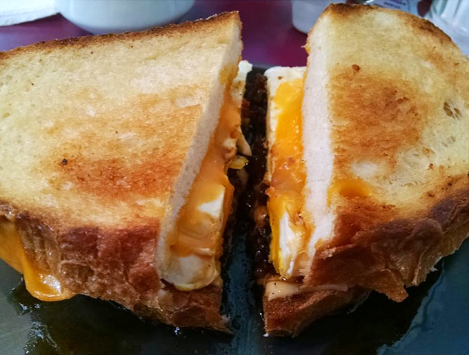 The humble grilled cheese elevated to art form – golden, buttery bread barely containing the molten cheese that stretches with each bite.