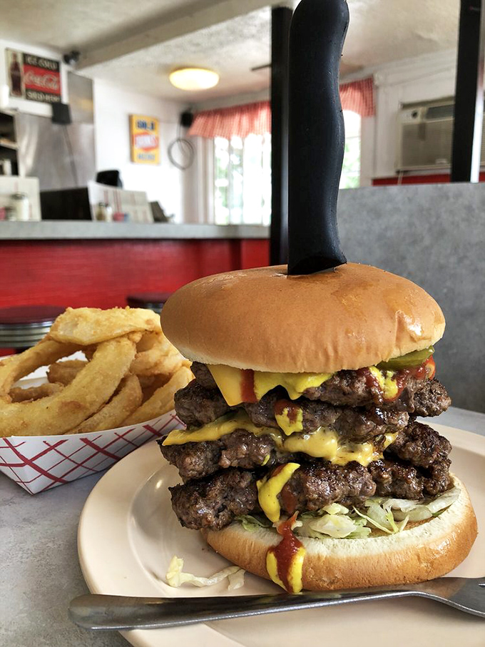 That towering masterpiece isn't just a grilled cheese sandwich&mdash;it's architectural genius stacked with multiple beef patties, melty cheese, and enough height to make you unhinge your jaw like a python.