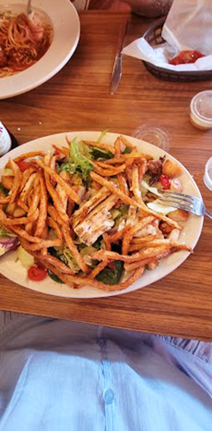 When french fries become the crown on a salad, you know you're in a place that understands joy isn't counting calories.