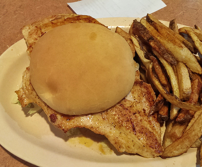 This isn't just a sandwich; it's a masterpiece of simplicity. Golden-brown chicken peeking out from under a bun with hand-cut fries standing guard.