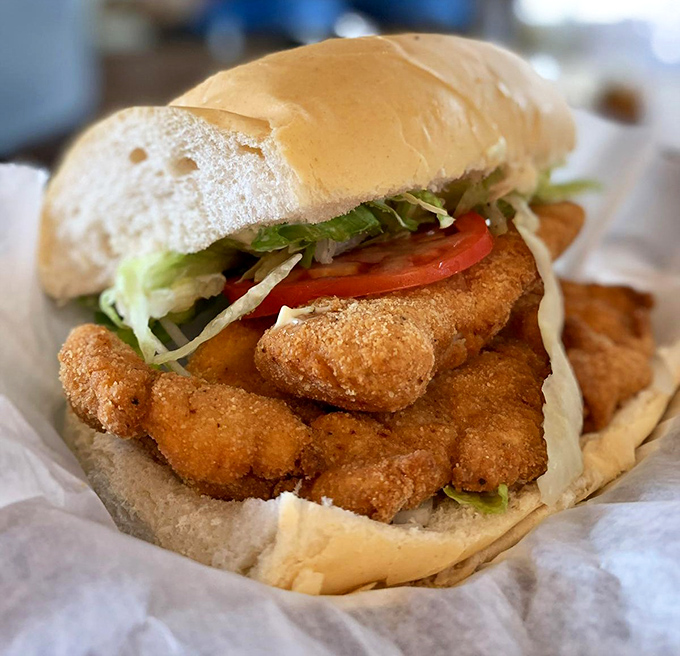 This grouper sandwich isn't just lunch &ndash; it's a Florida masterpiece with crispy fish spilling over the bun like it's trying to return to the sea.